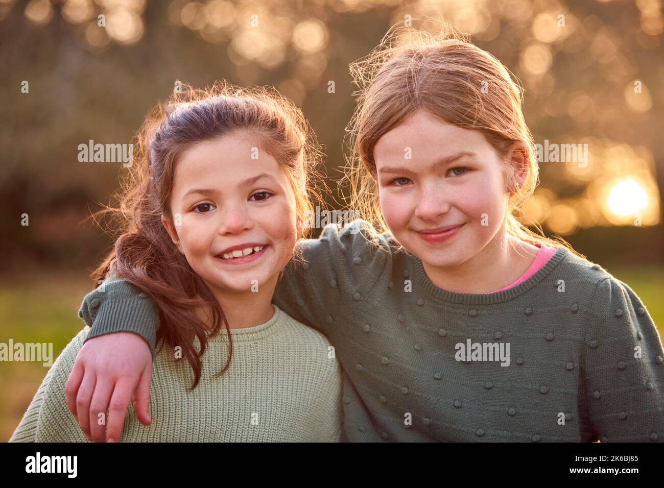 Portrait Of Two Girls Outdoors With Arms Around Each Other Stock Photo ...