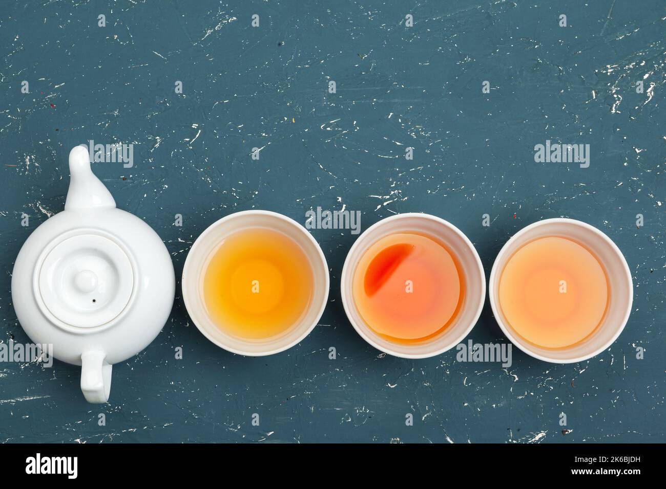 Collection of different teas in cups with tea leaves Stock Photo - Alamy