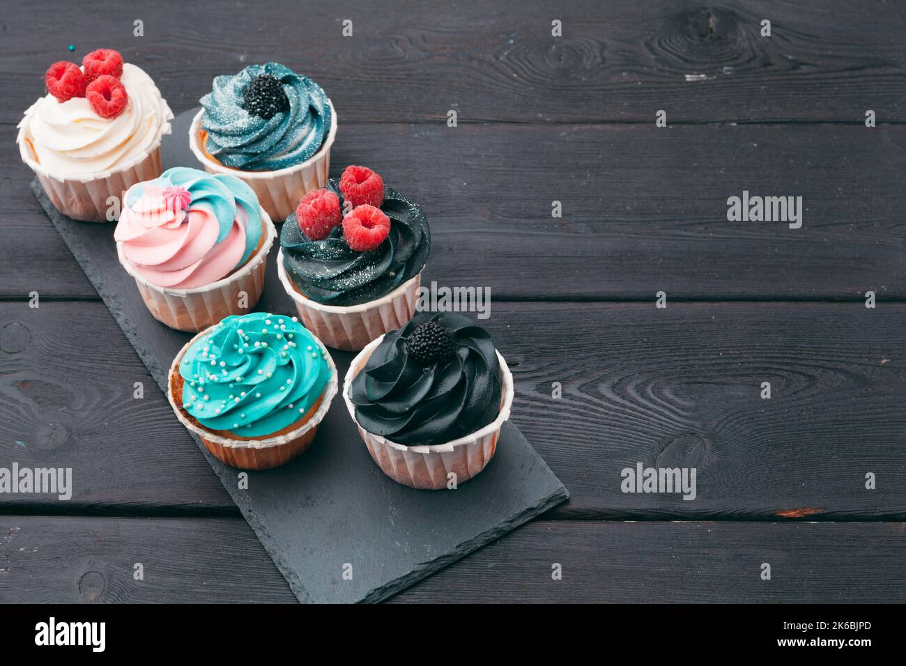 Set of different delicious cupcakes on dark Stock Photo - Alamy