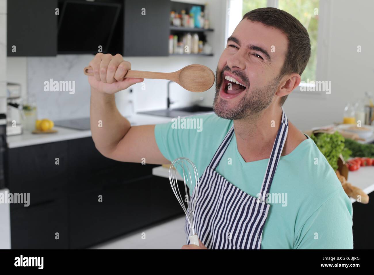 Man singing in the kitchen Stock Photo - Alamy