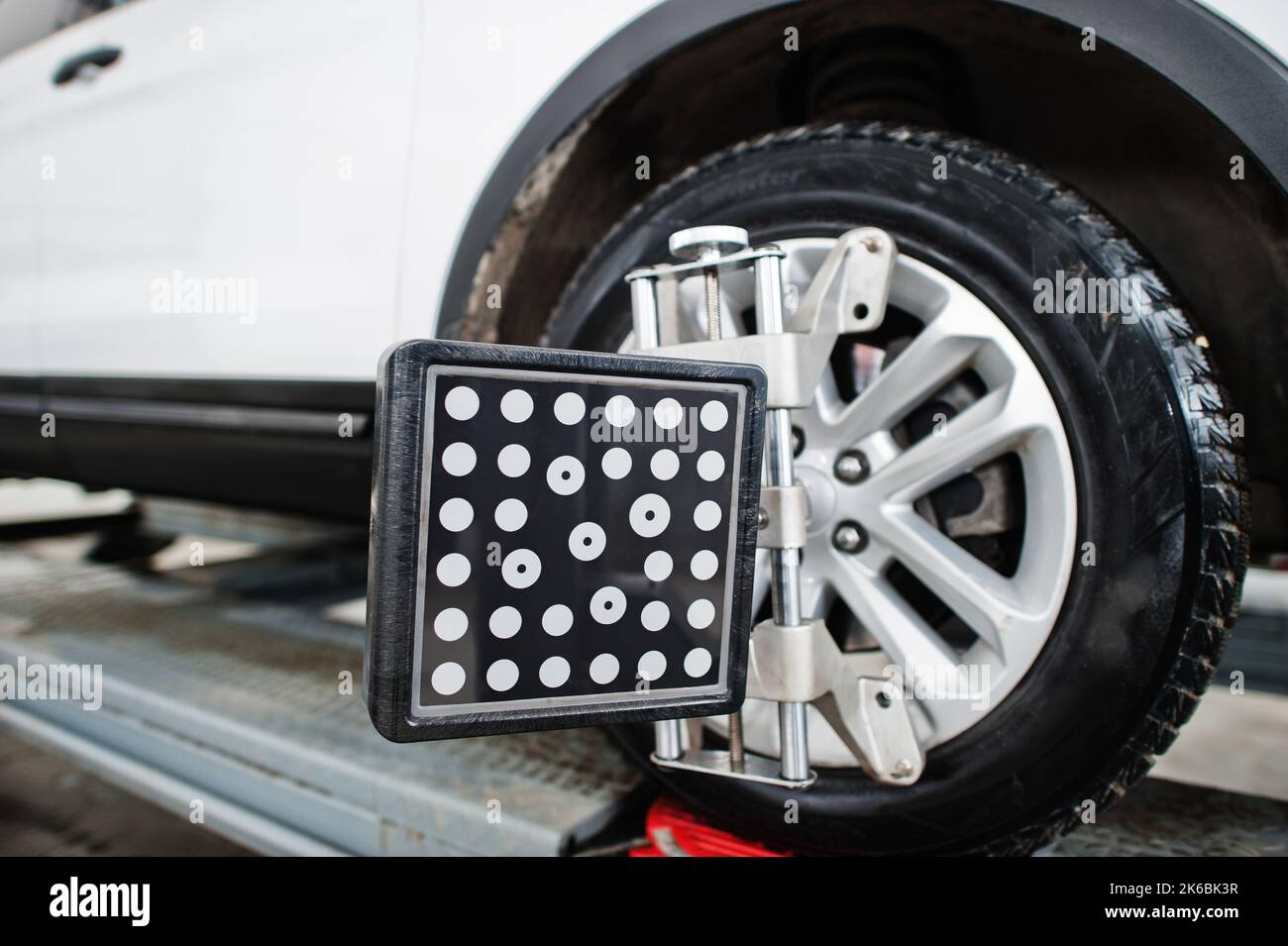 American SUV car on stand for wheels alignment camber check in workshop ...
