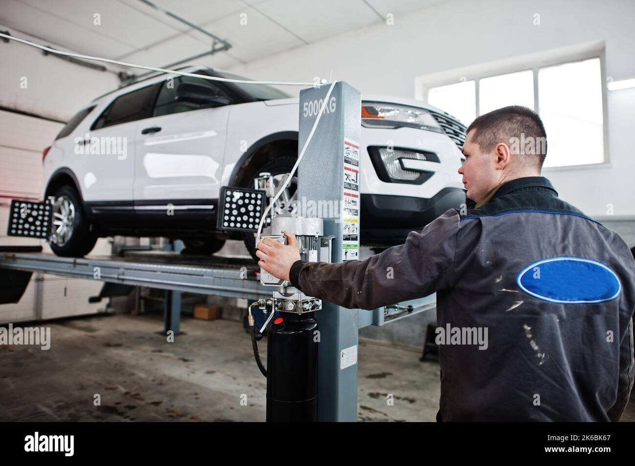 Auto mechanic sets american SUV car for diagnostics and configuration ...