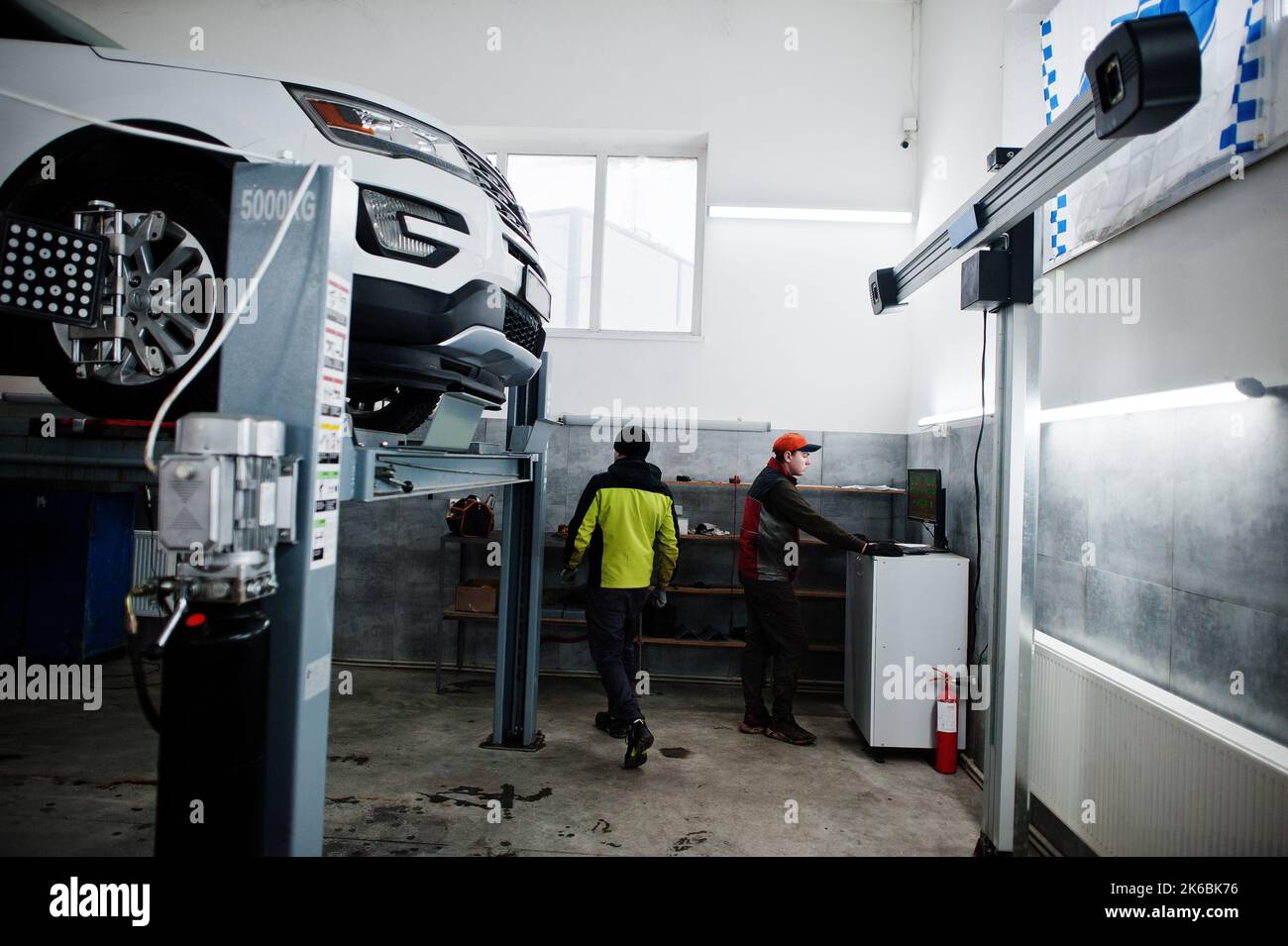 Auto mechanic sets american SUV car for diagnostics and configuration ...