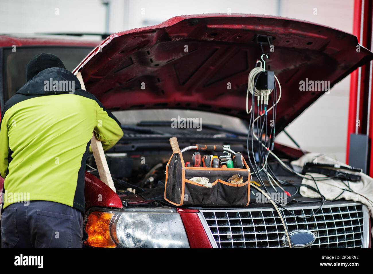 Auto mechanic sets american SUV car for diagnostics and configuration ...