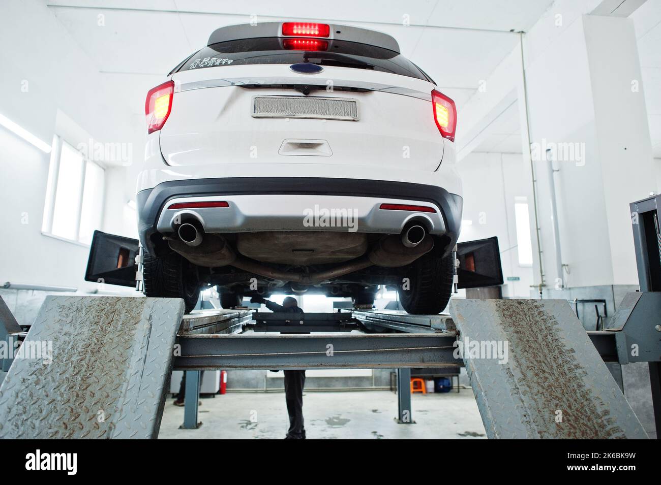 American SUV car on stand for wheels alignment camber check in workshop ...