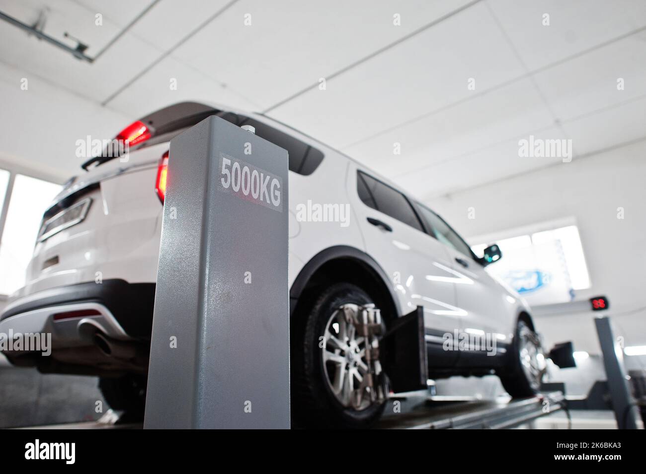 American SUV car on stand for wheels alignment camber check in workshop ...