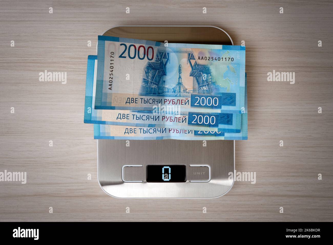 Dollar bills on the electronic scales, a symbol of cost reduction ...