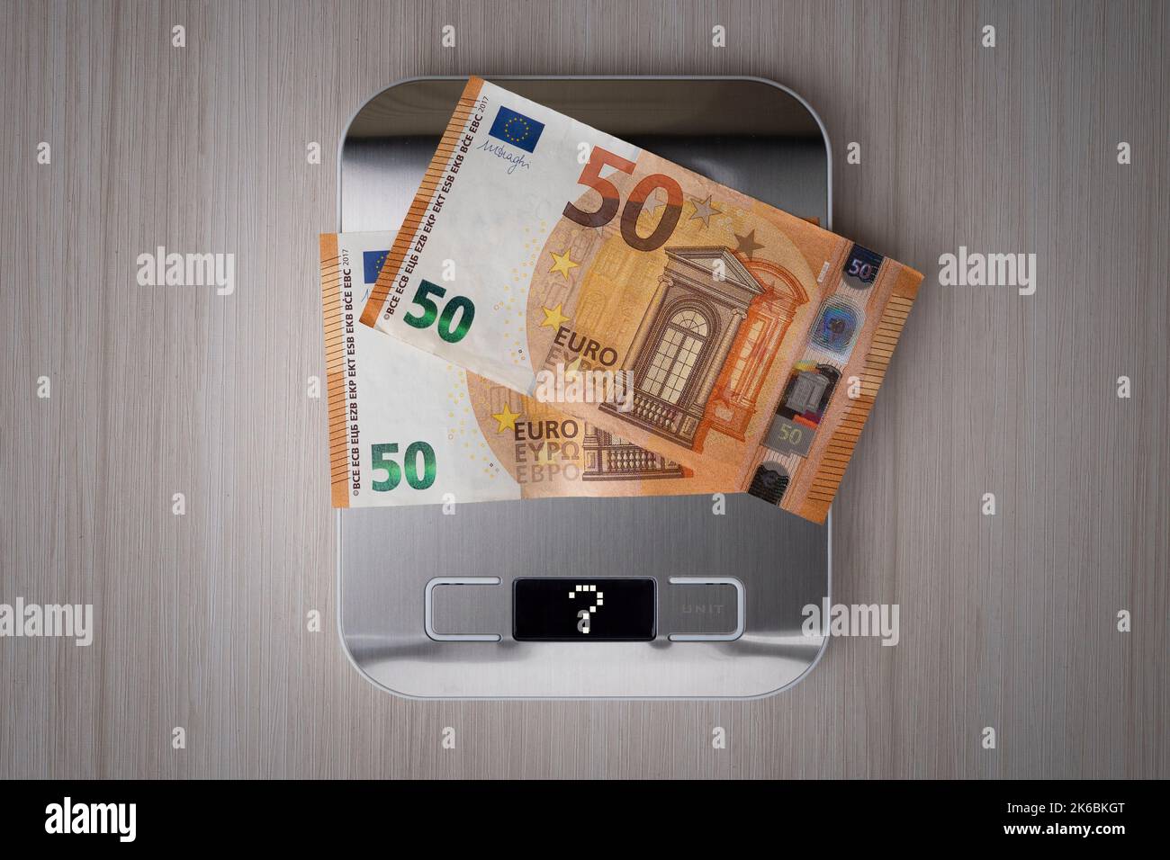 euro bills on the electronic scales, a symbol of cost reduction ...