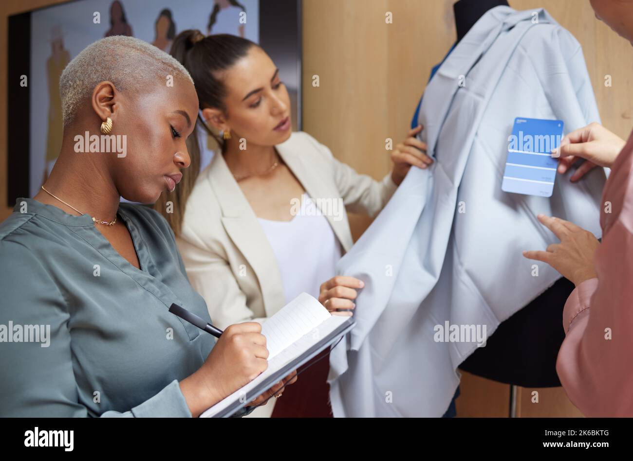 Pick the perfect colour. a group of female designers working in an ...