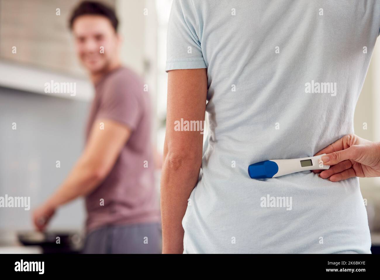 Transgender Couple At Home In Kitchen With Woman Surprising Man With ...