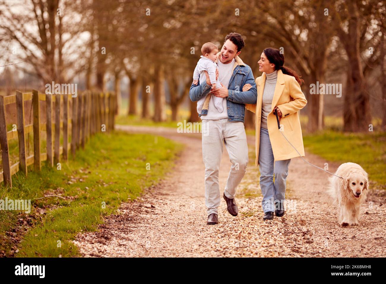Transgender Family With Baby And Pet Dog Enjoying Walk In Autumn Or ...