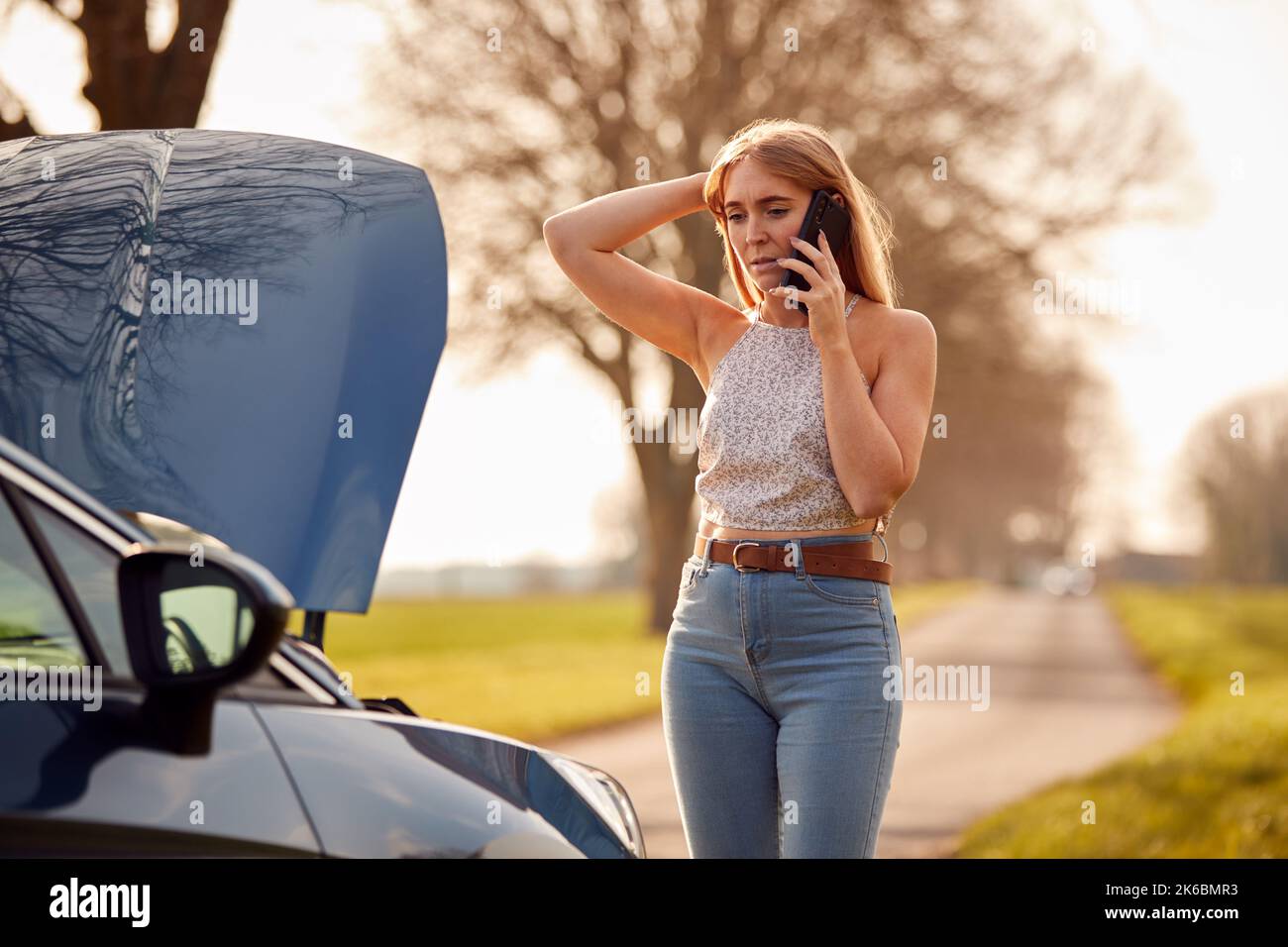 Woman With Broken Down Car On Country Road Calling For Help On Mobile ...