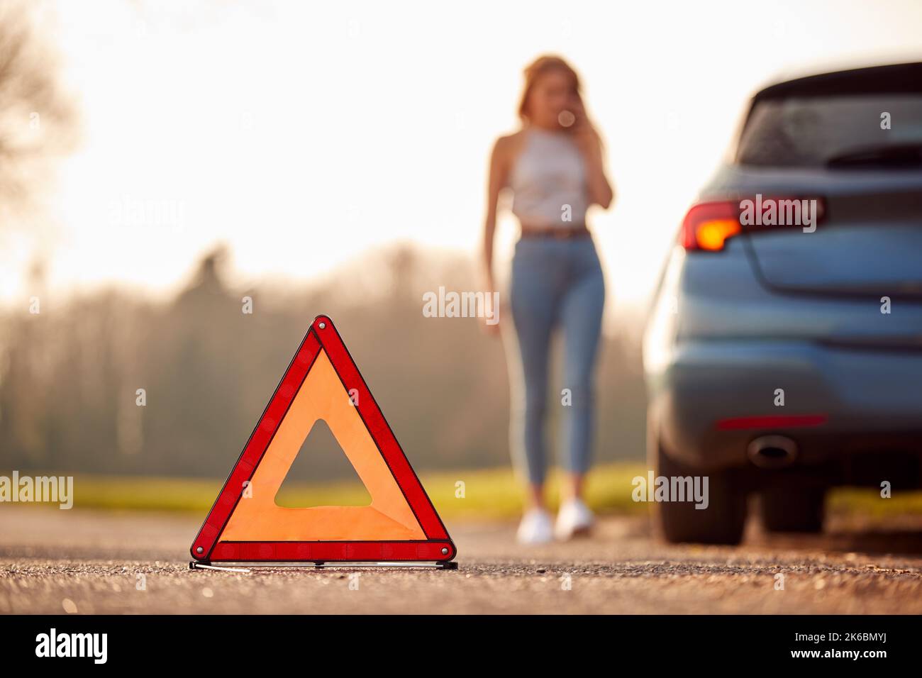 Hazard Warning Triangle Sign For Car Breakdown On Road With Woman ...
