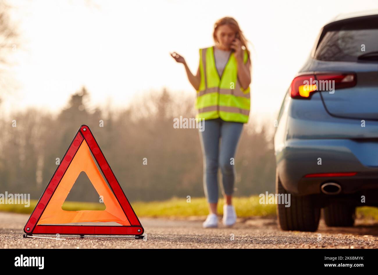 Hazard Warning Triangle Sign For Car Breakdown On Road With Woman ...