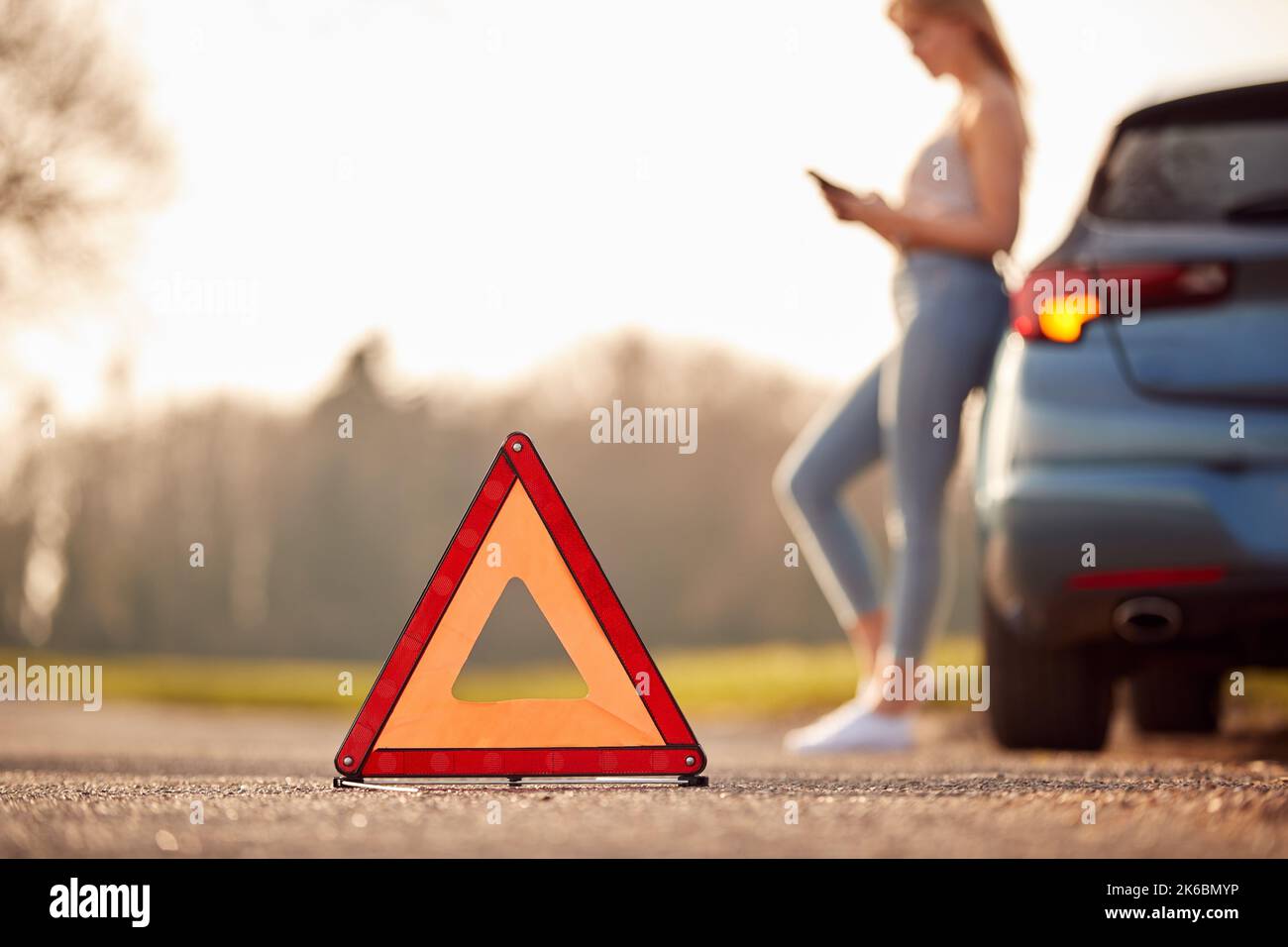 Hazard Warning Triangle Sign For Car Breakdown On Road With Woman ...