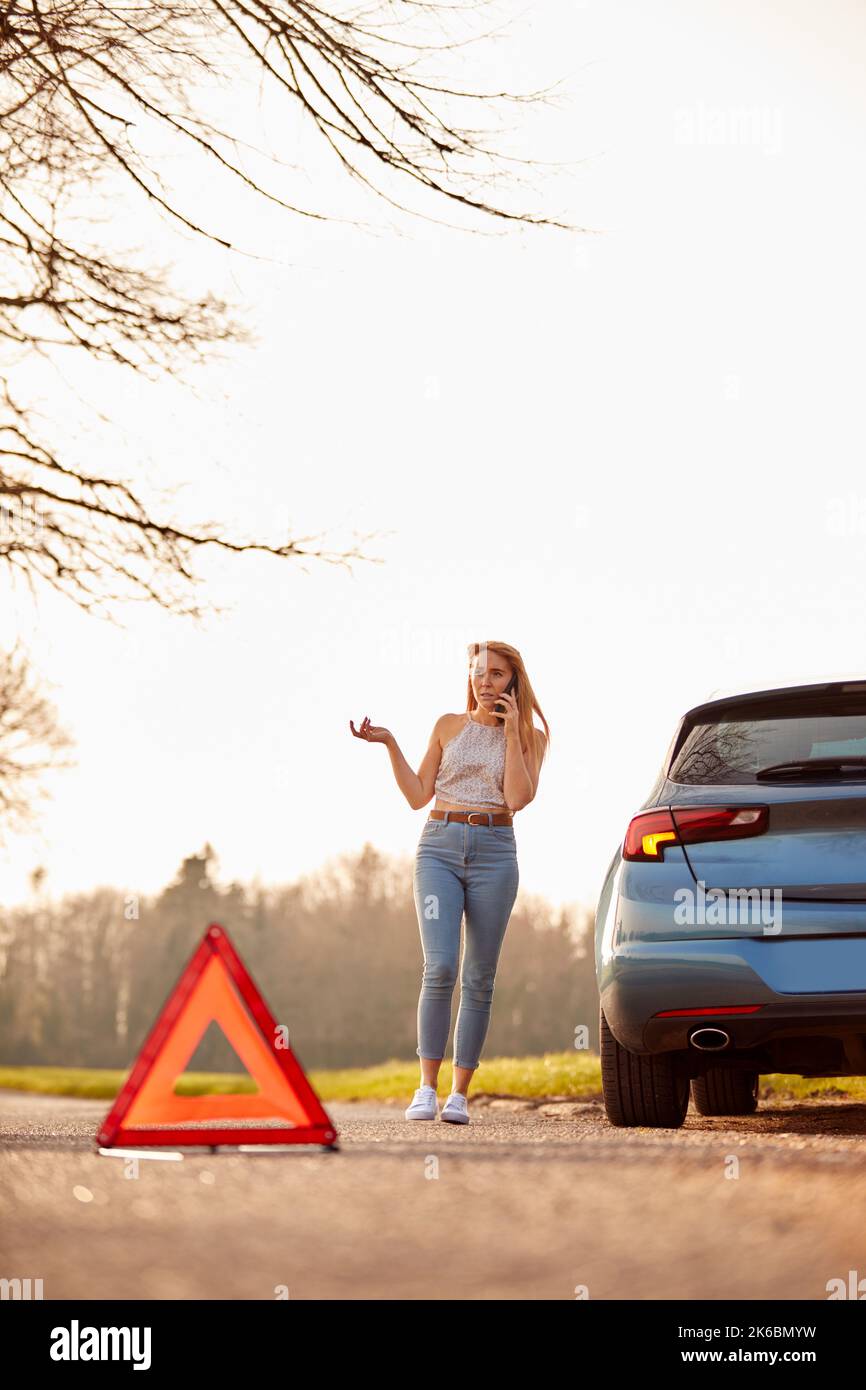 Hazard Warning Triangle Sign For Car Breakdown On Road With Woman ...