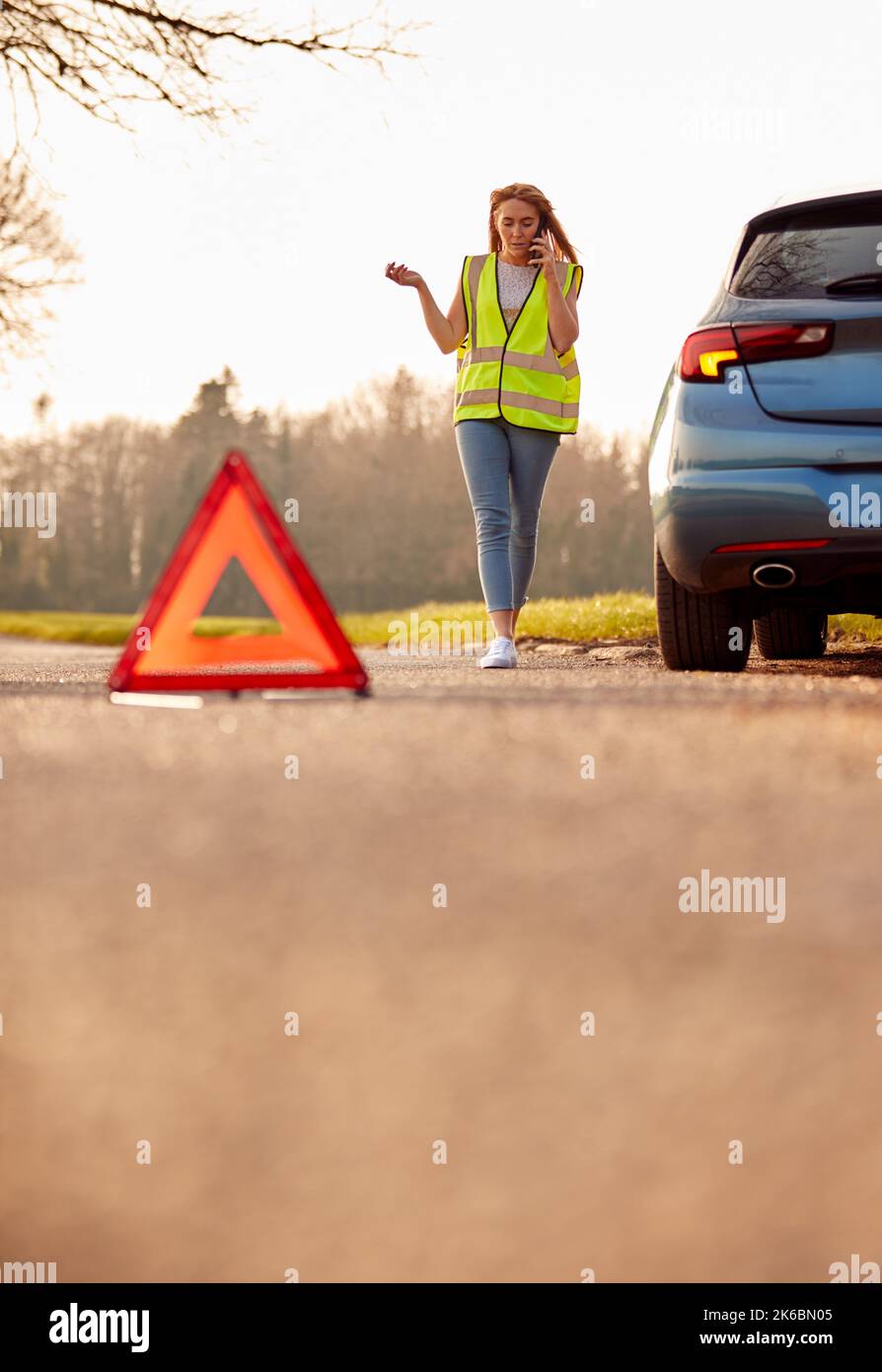 Hazard Warning Triangle Sign For Car Breakdown On Road With Woman ...