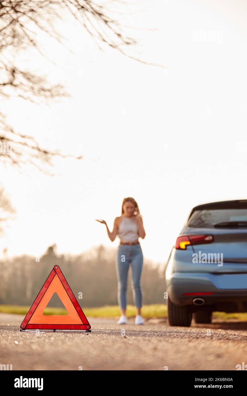 Hazard Warning Triangle Sign For Car Breakdown On Road With Woman ...