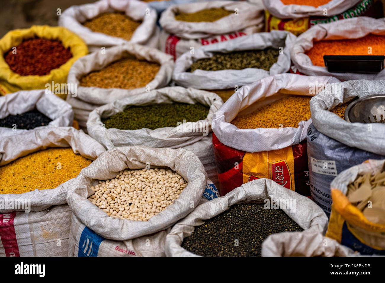 A closeup of various beans, spices, vegetables sold at a market in ...