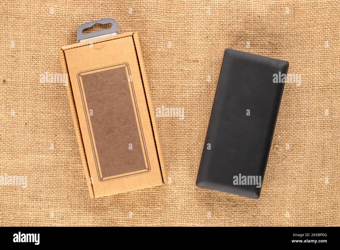 One new black portable battery with paper packaging on jute cloth ...