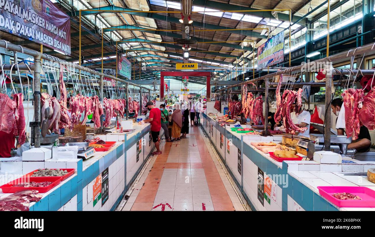 View of meat seller at meat section in busy traditional market of ...