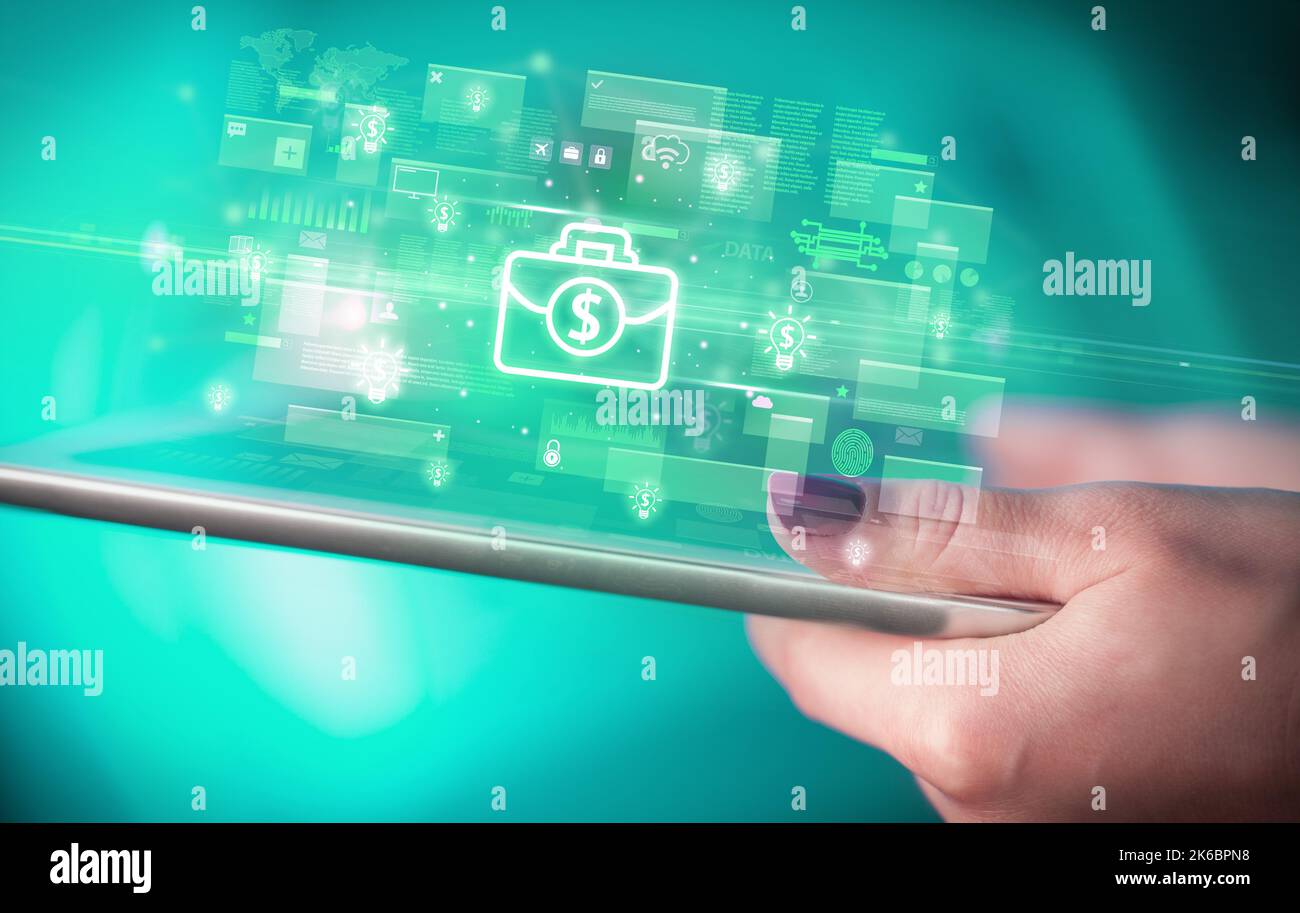 Close-up of a hand using tablet, currency concept Stock Photo - Alamy