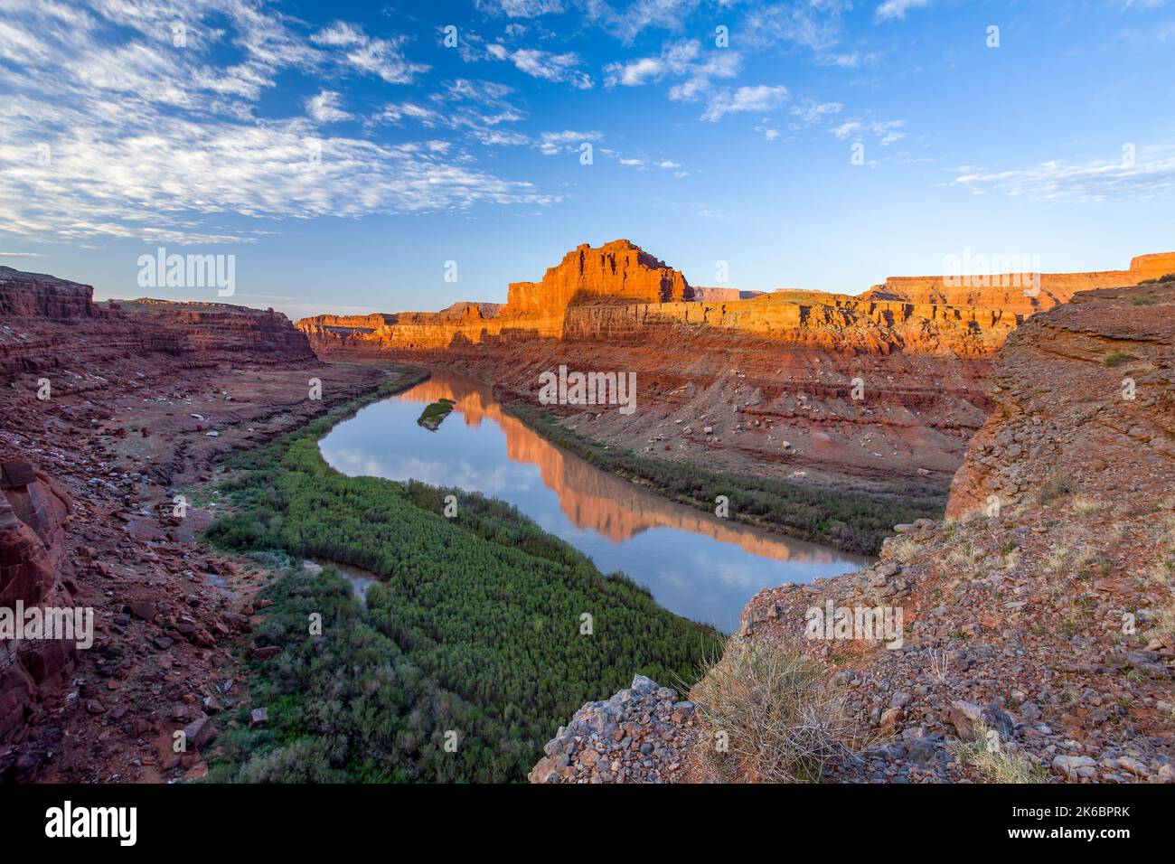 Moenkopi sandstone butte reflected in the Colorado River at the Goose ...