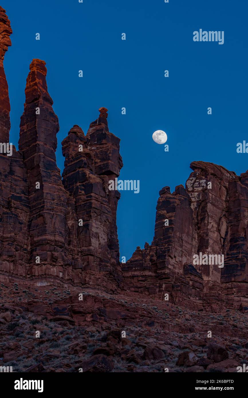 Waxing gibbous moon rising over sandstone formations along the Colorado ...