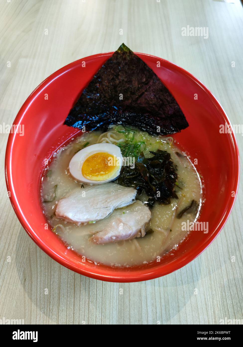 Close up top view of hot chicken ramen noodle soup with topping egg ...