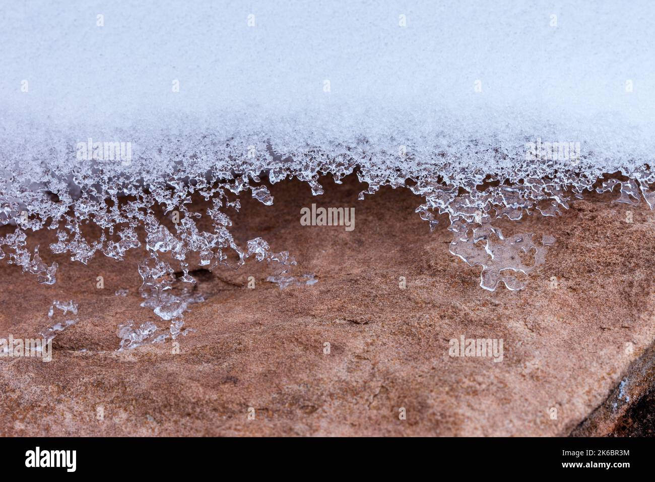 Close-up view of melting ice patterns in winter in Arches National Park ...