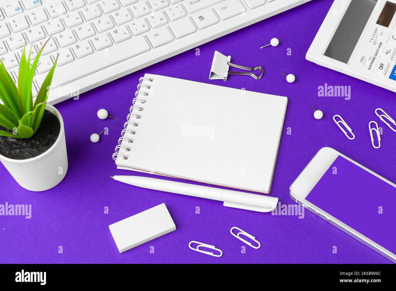 Composition of office lifestyle items on purple background, computer ...