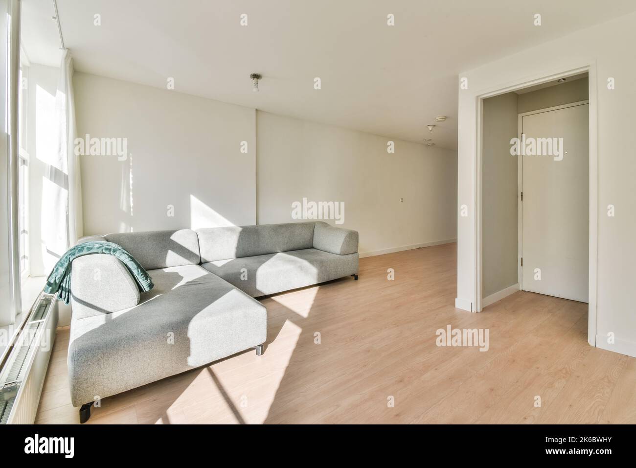 Comfortable sofa near window in room of contemporary apartment Stock ...