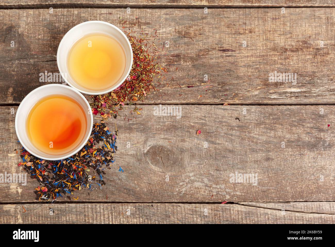 Collection of different teas in cups with tea leaves Stock Photo - Alamy