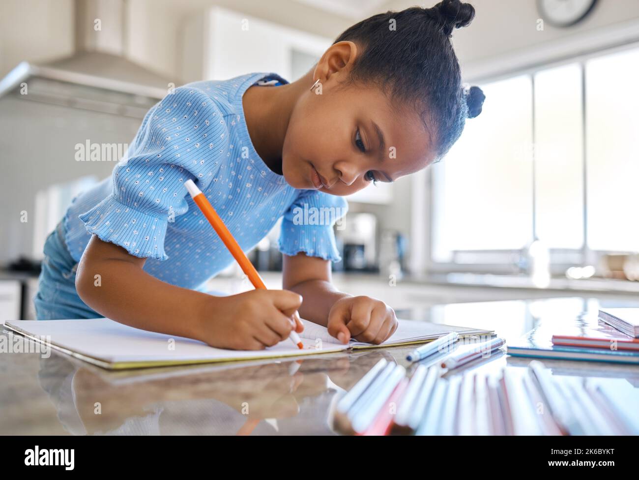 In her comfort zone. a little girl doing homework at home Stock Photo ...