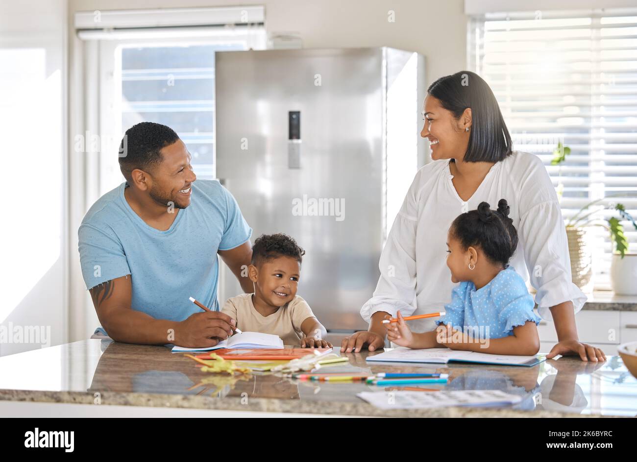 This is called teamwork. parents helping their children with homework at home Stock Photo - Alamy