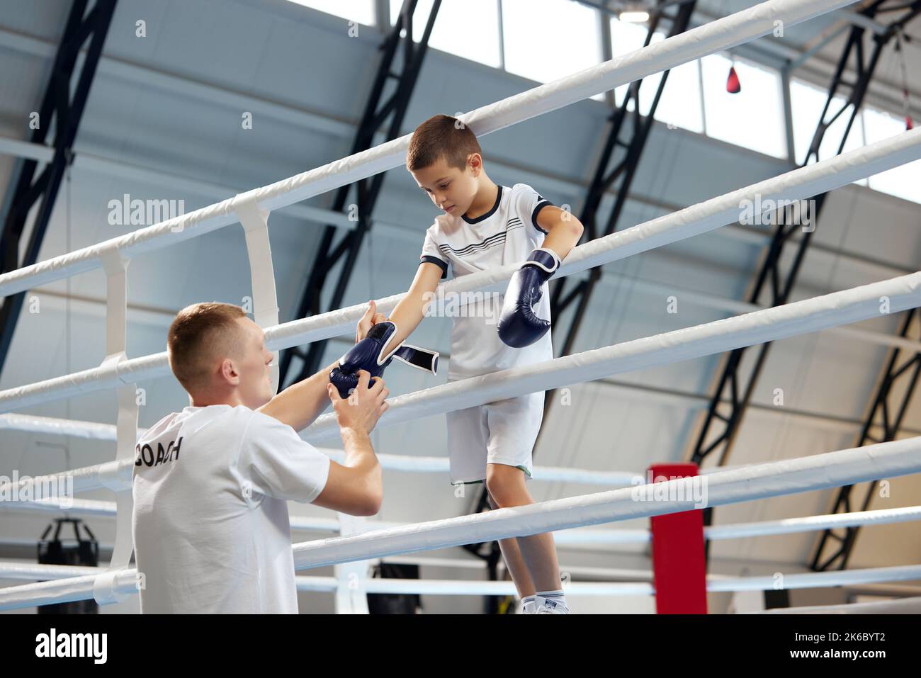 Help, support. Junior athlete, male boxer training with personal coach ...