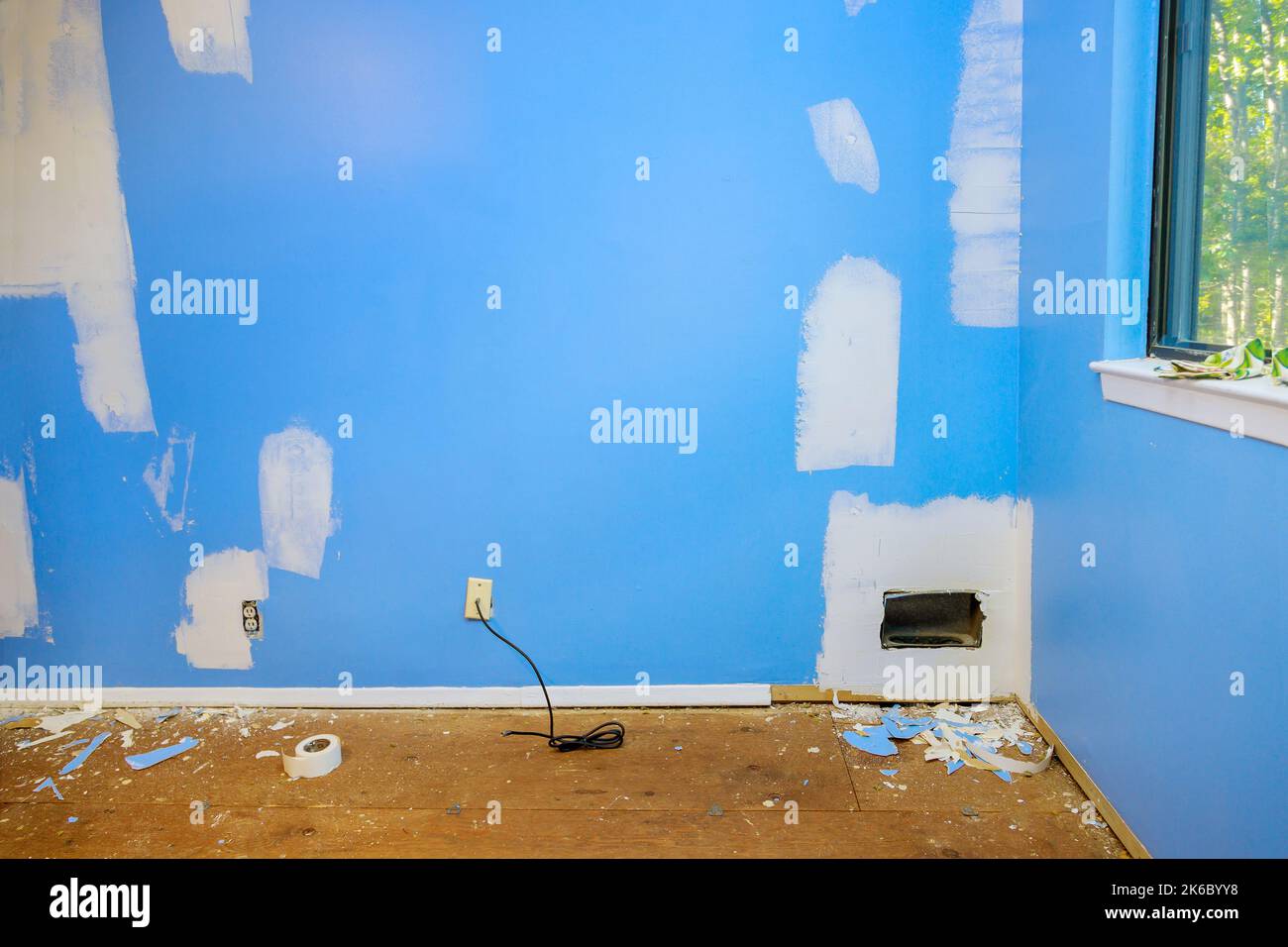 Damaged cracks in wall, drywall ceiling, and use spatula to put gypsum ...