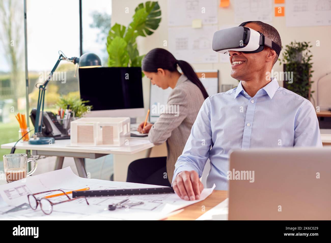 Male Architect In Office Using VR Headset To Design New Building Stock ...