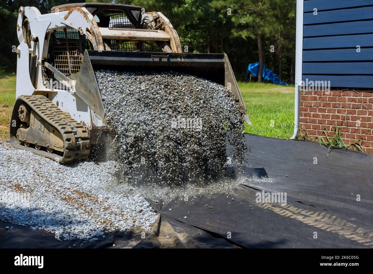 In to install storage shed near house, tractor uploaded gravel to ...
