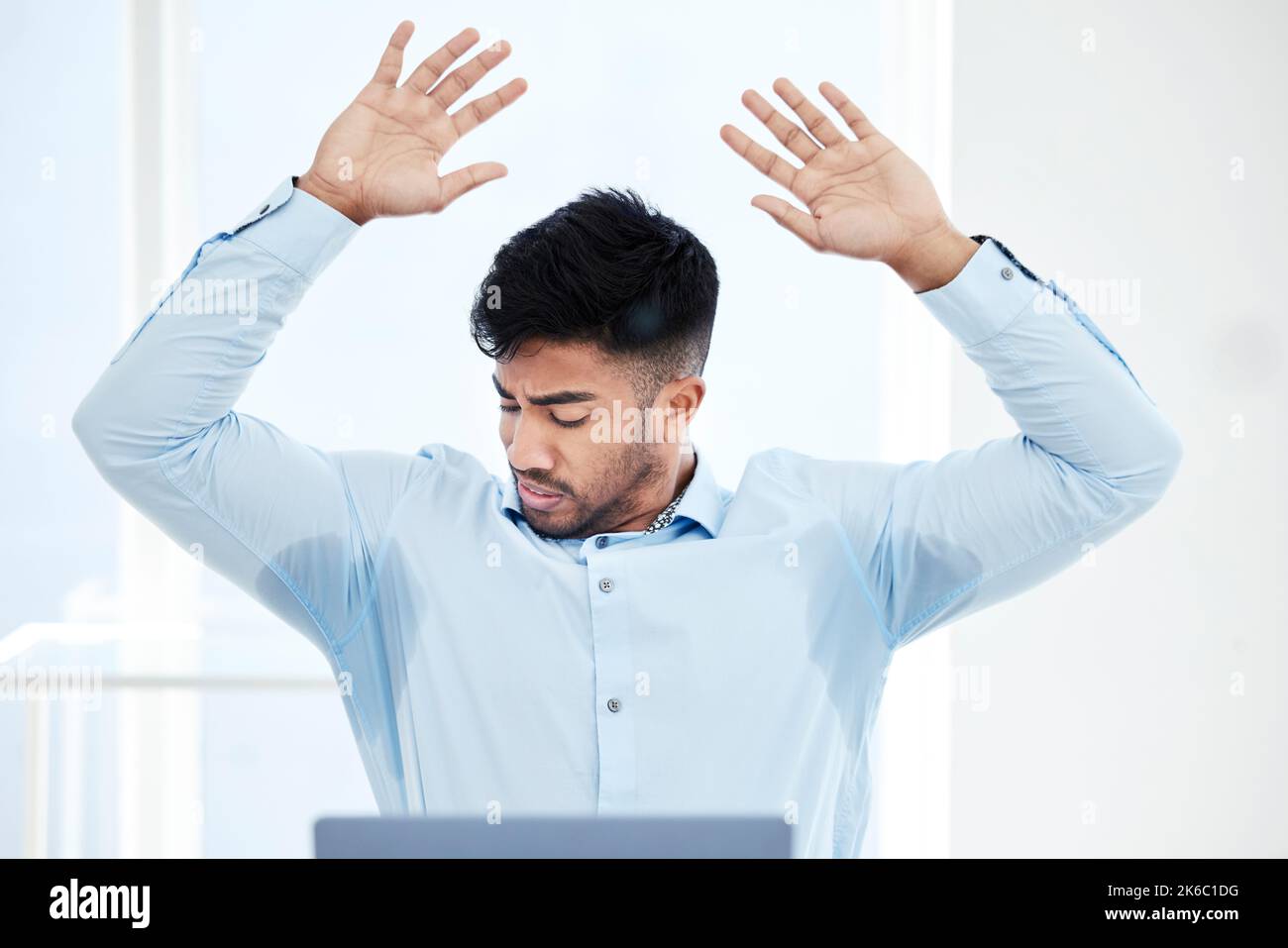 All sweaty and stressed. a young businessman with sweat stained through ...