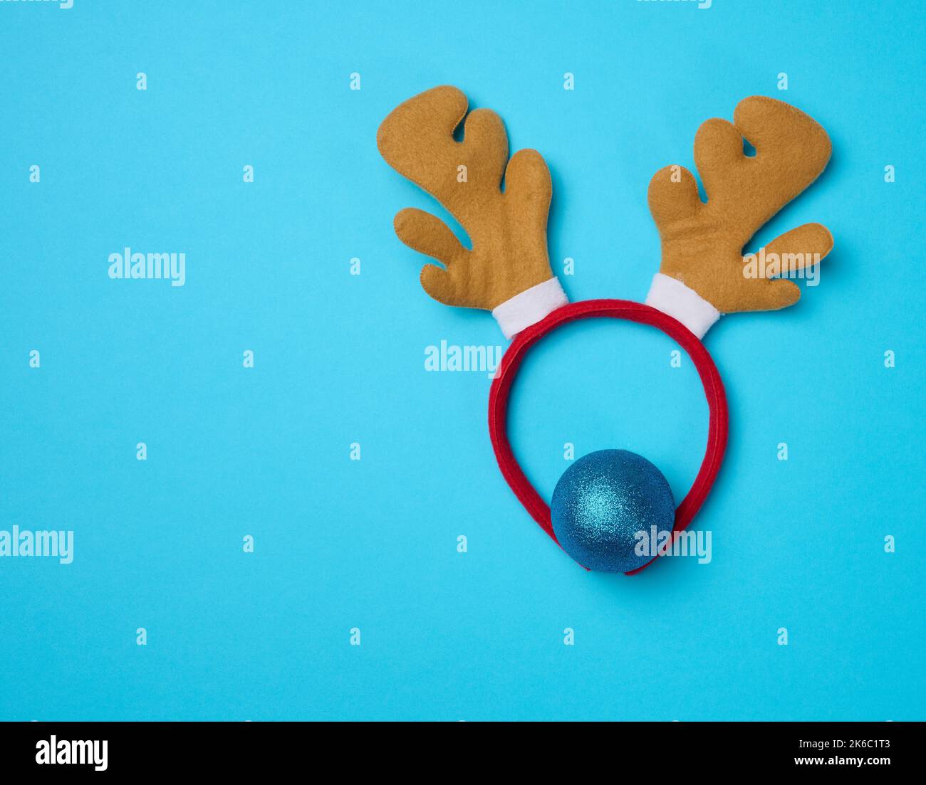 Christmas deer costume with antlers on the head on a blue background ...