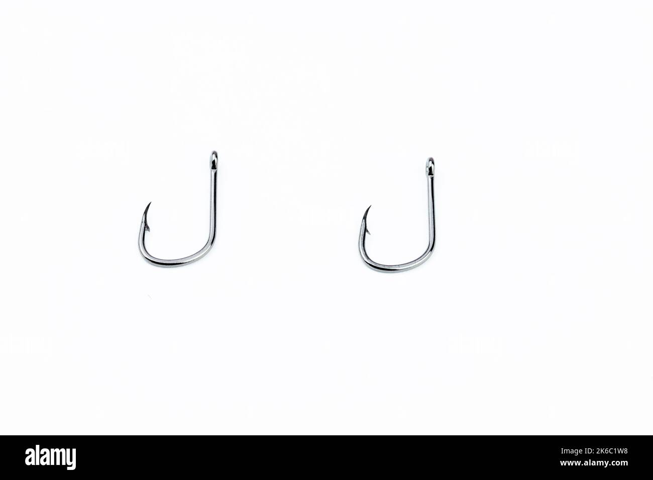 Two fishing hooks isolated on white background Stock Photo - Alamy