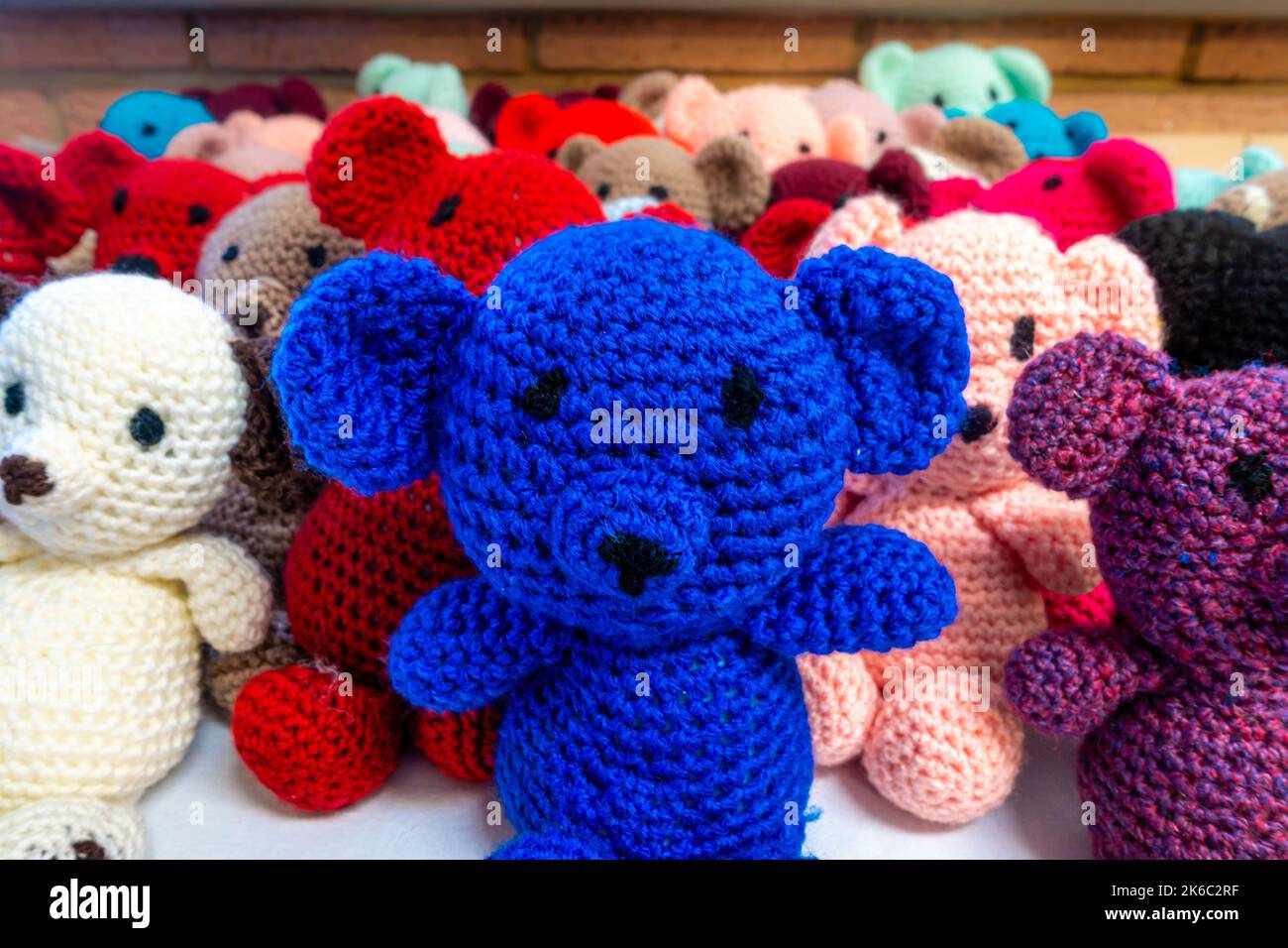 Knitted teddy bears in colourful colours ready to give out as gifts to ...
