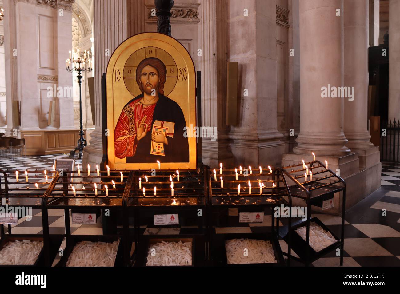 The icon of Christ in the church with burning candles Stock Photo - Alamy