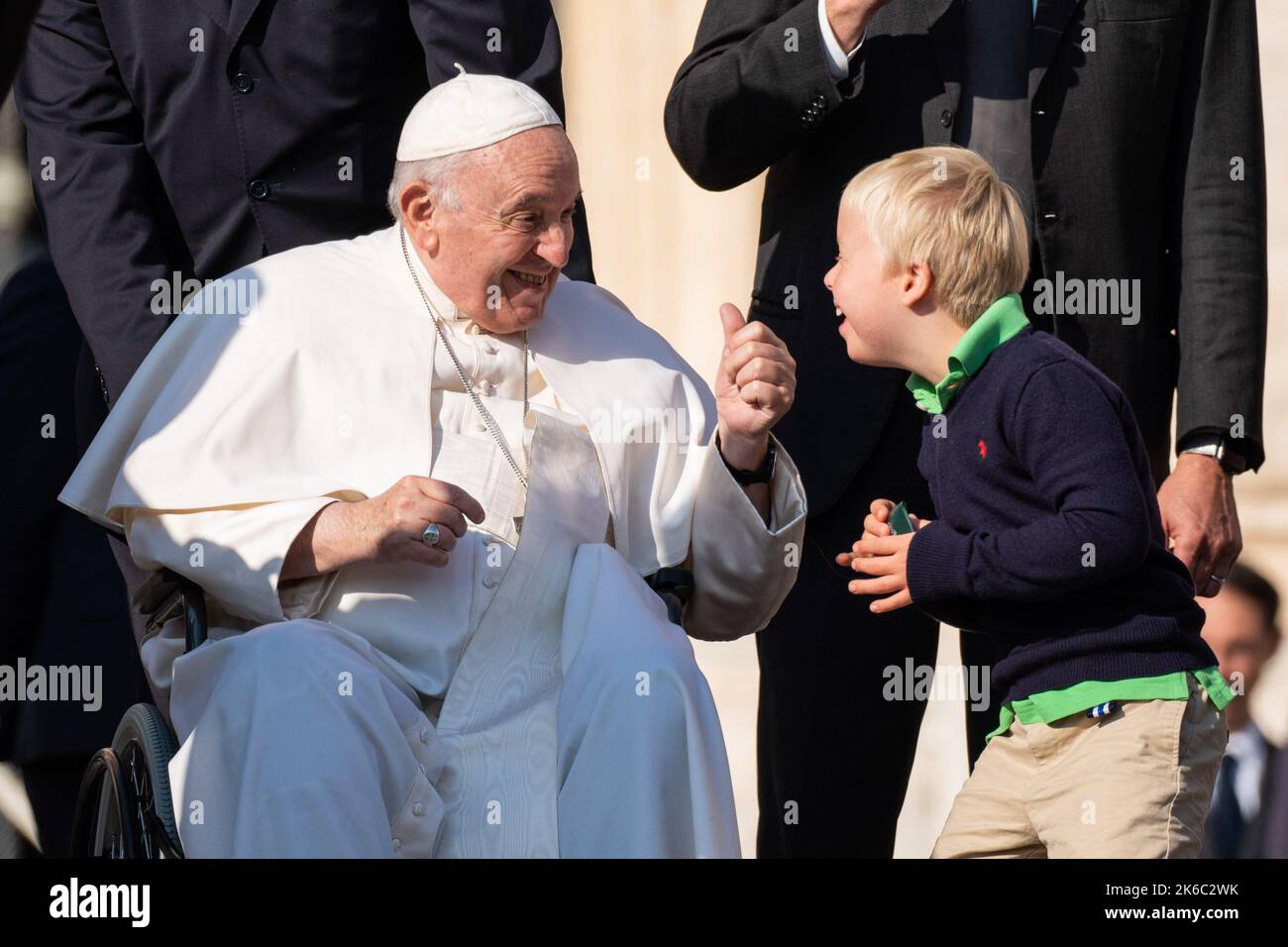 Pope Francis plays and jokes with a child during his traditional ...