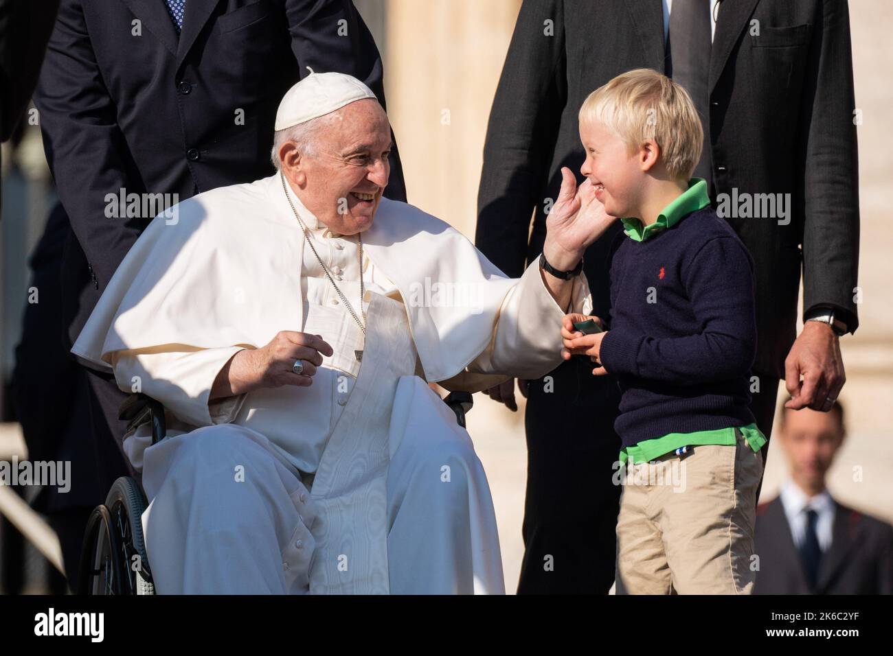 Pope Francis plays and jokes with a child during his traditional ...