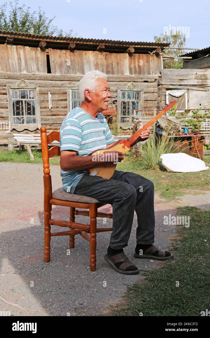 Playing a hand-made traditional Komuz, Ak-Orgo Workshop, Barskoon ...