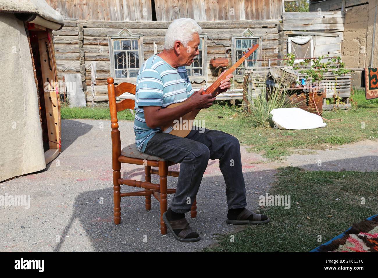 Playing a hand-made traditional Komuz, Ak-Orgo Workshop, Barskoon ...