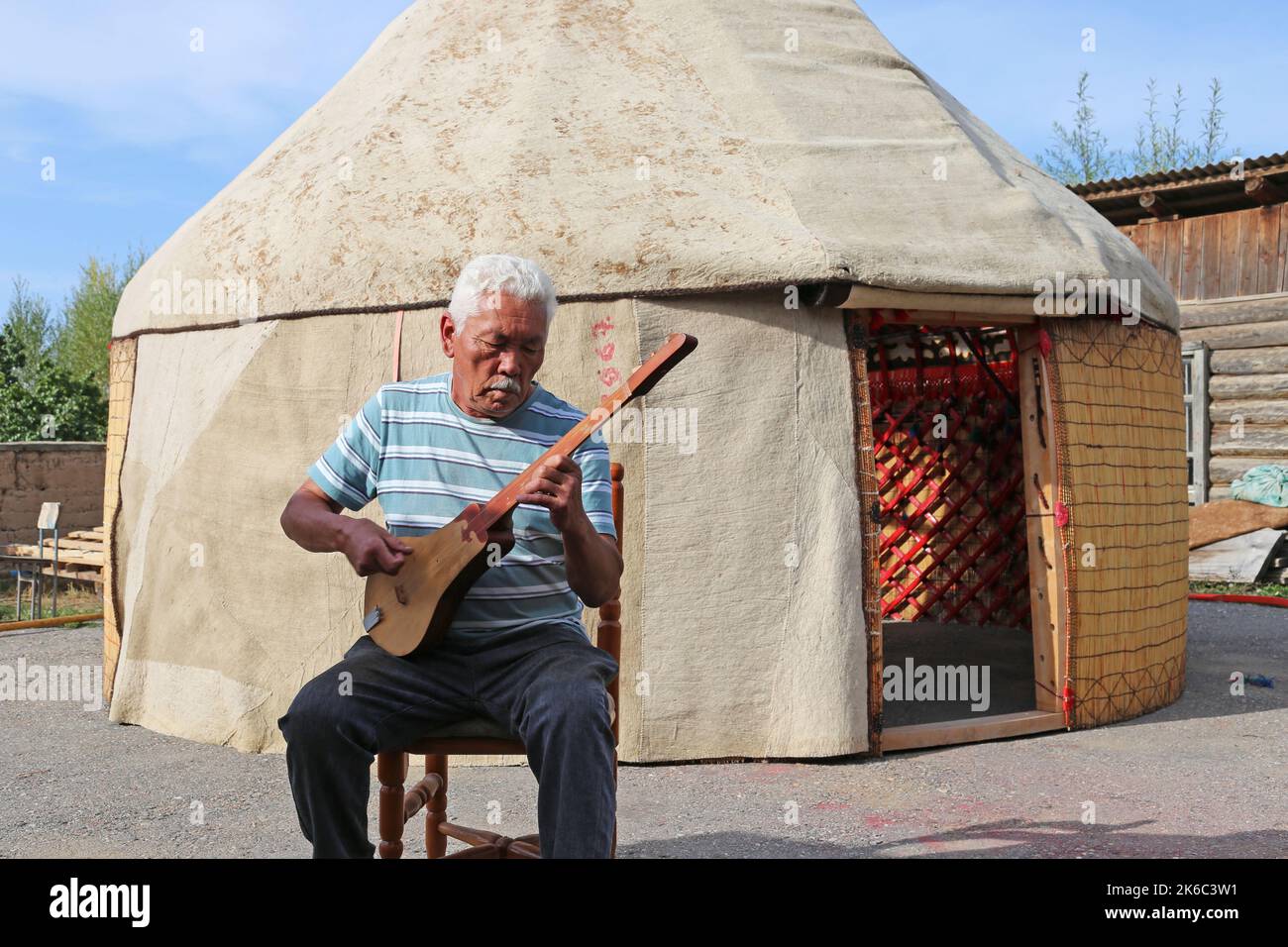Playing a hand-made traditional Komuz, Ak-Orgo Workshop, Barskoon ...
