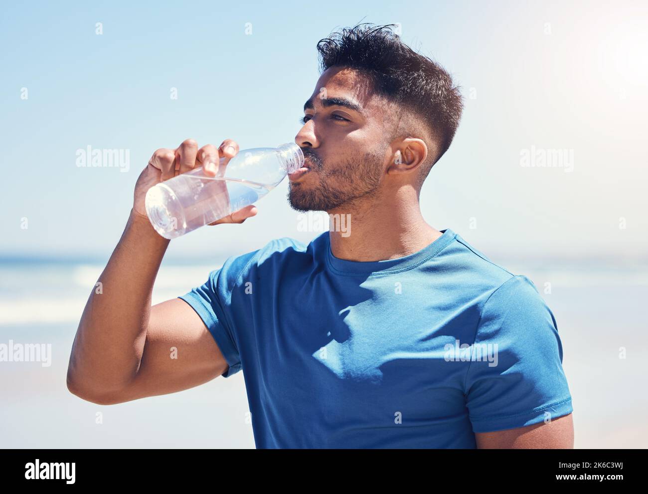 Live, exercise and drink water. a man drinking water while out for a ...